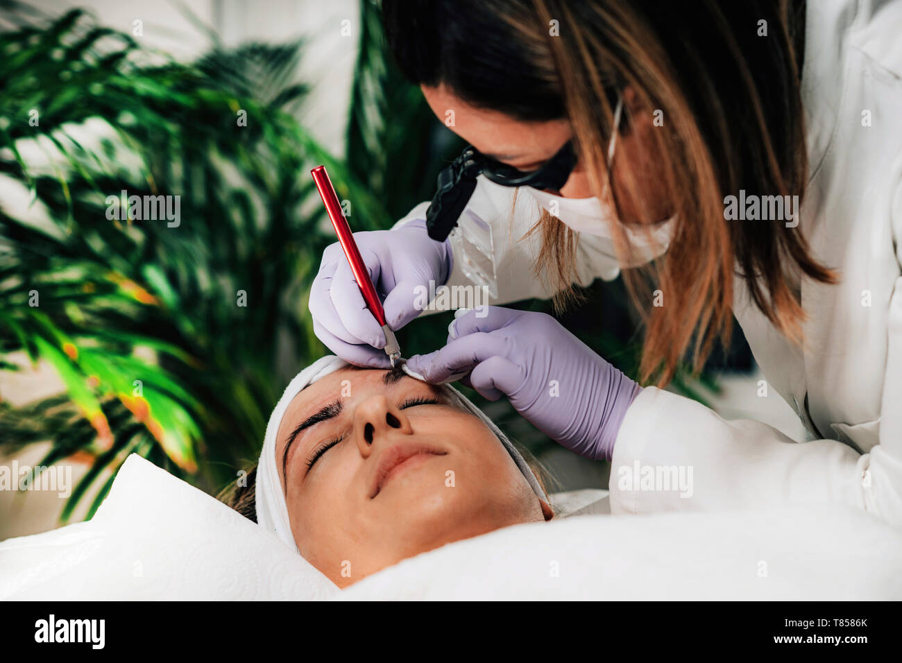 Close up eyebrow tattooing procedure hi-res stock photography and ...