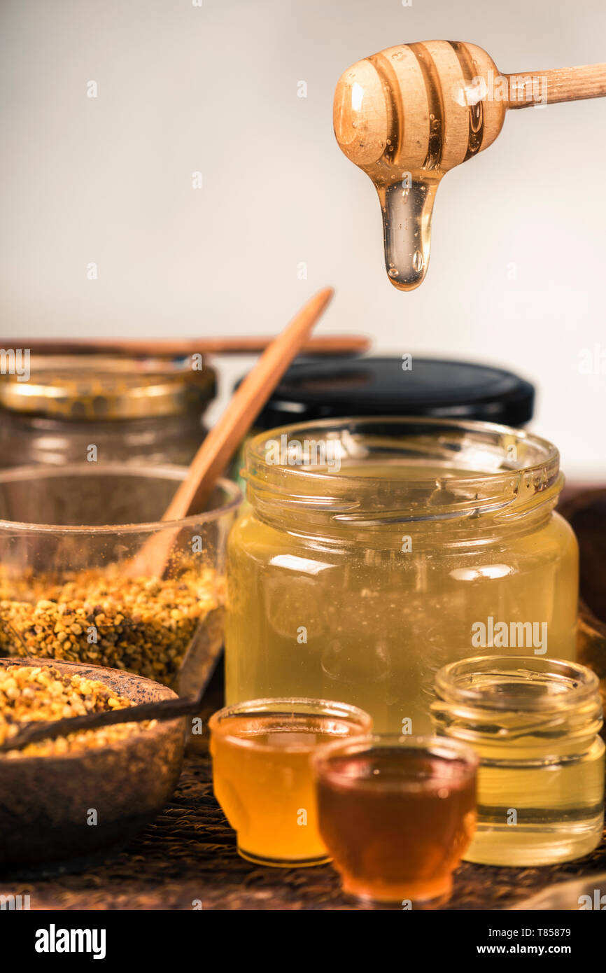 Honey flowing into a glass jar Stock Photo - Alamy