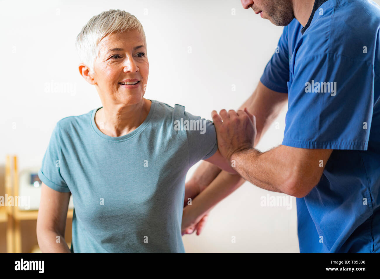 Physiotherapist examining patients arm hi-res stock photography and ...
