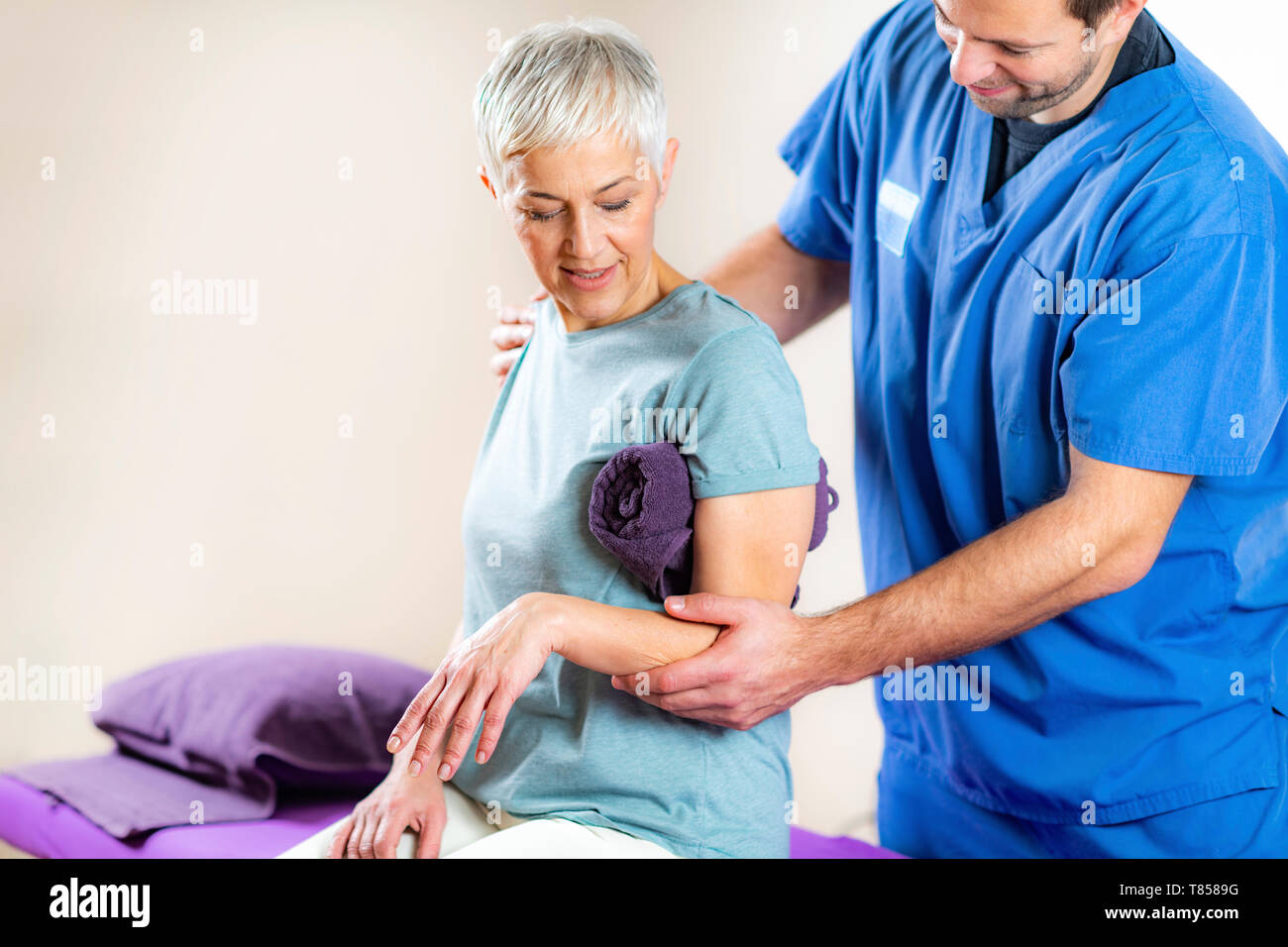 Physical therapist examining senior hi-res stock photography and images ...