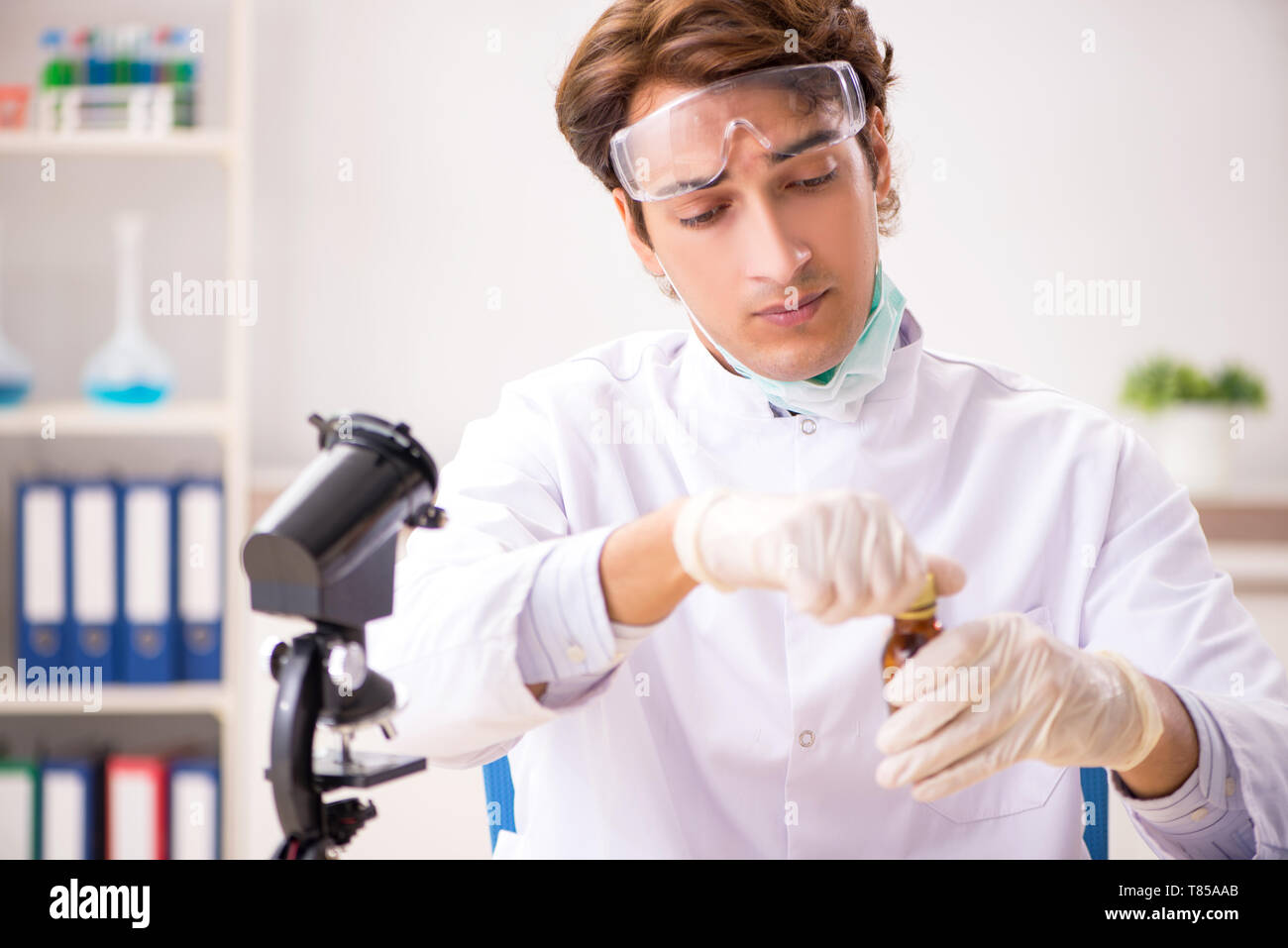 Male entomologist working in the lab on new species Stock Photo - Alamy