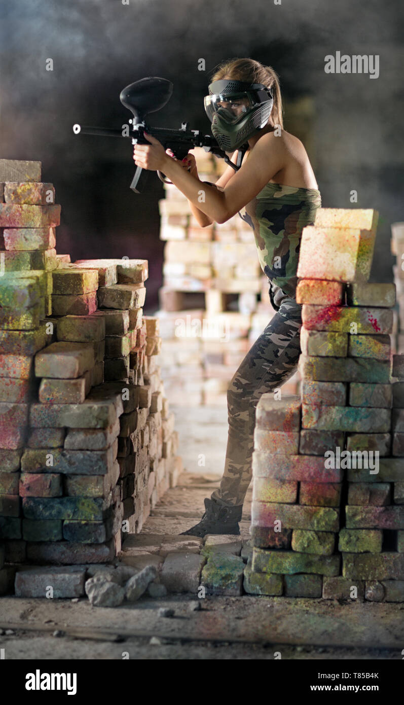 Paintball player with gun in action with protective mask Stock Photo ...