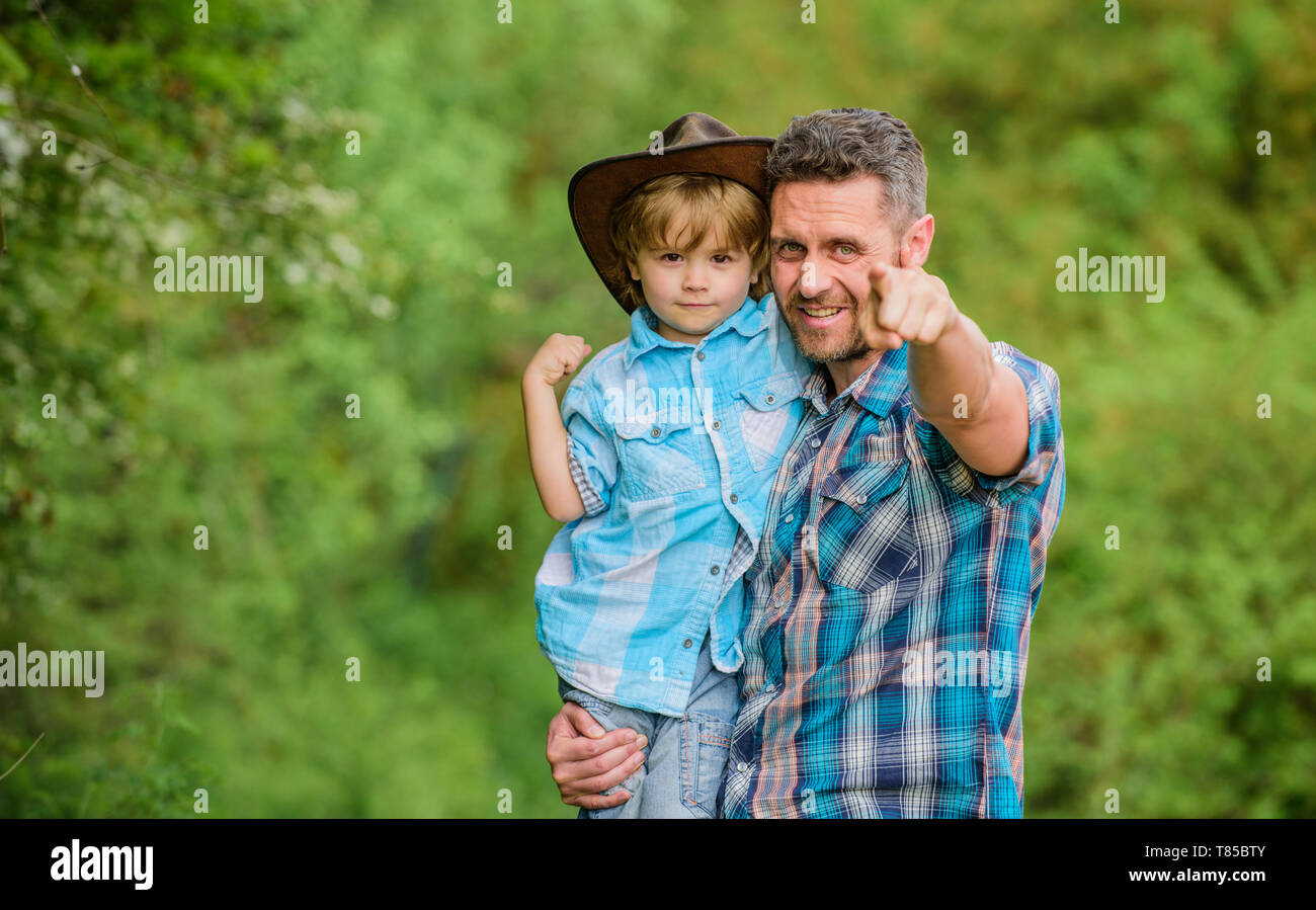 Growing cute cowboy. Small helper in garden. Little boy and father in ...