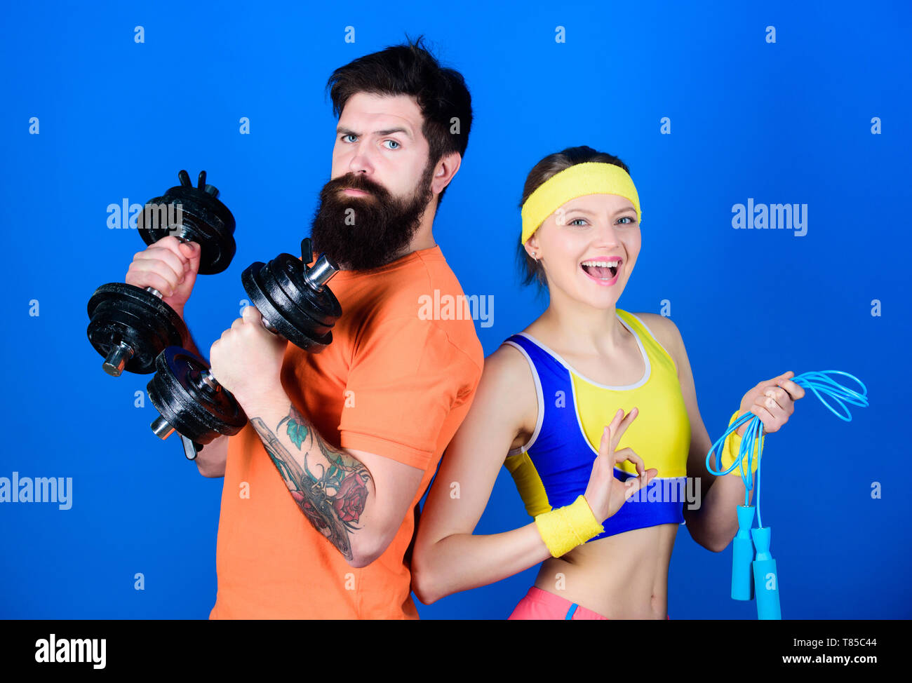be strong. Strong muscles and body. Sporty couple training with barbell ...
