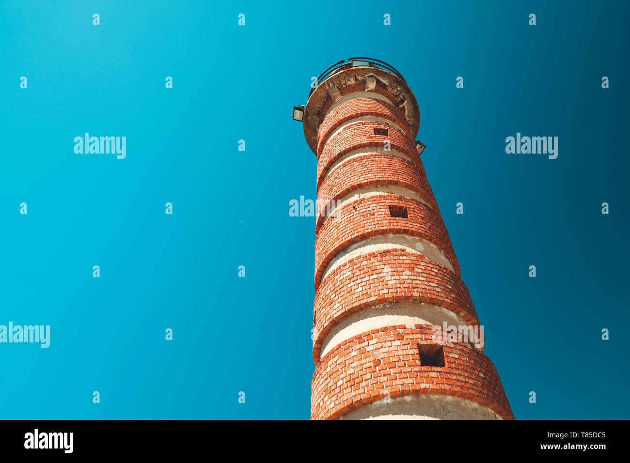 Old Brick Stone Lighthouse At Sea On Blue Sky Stock Photo - Alamy