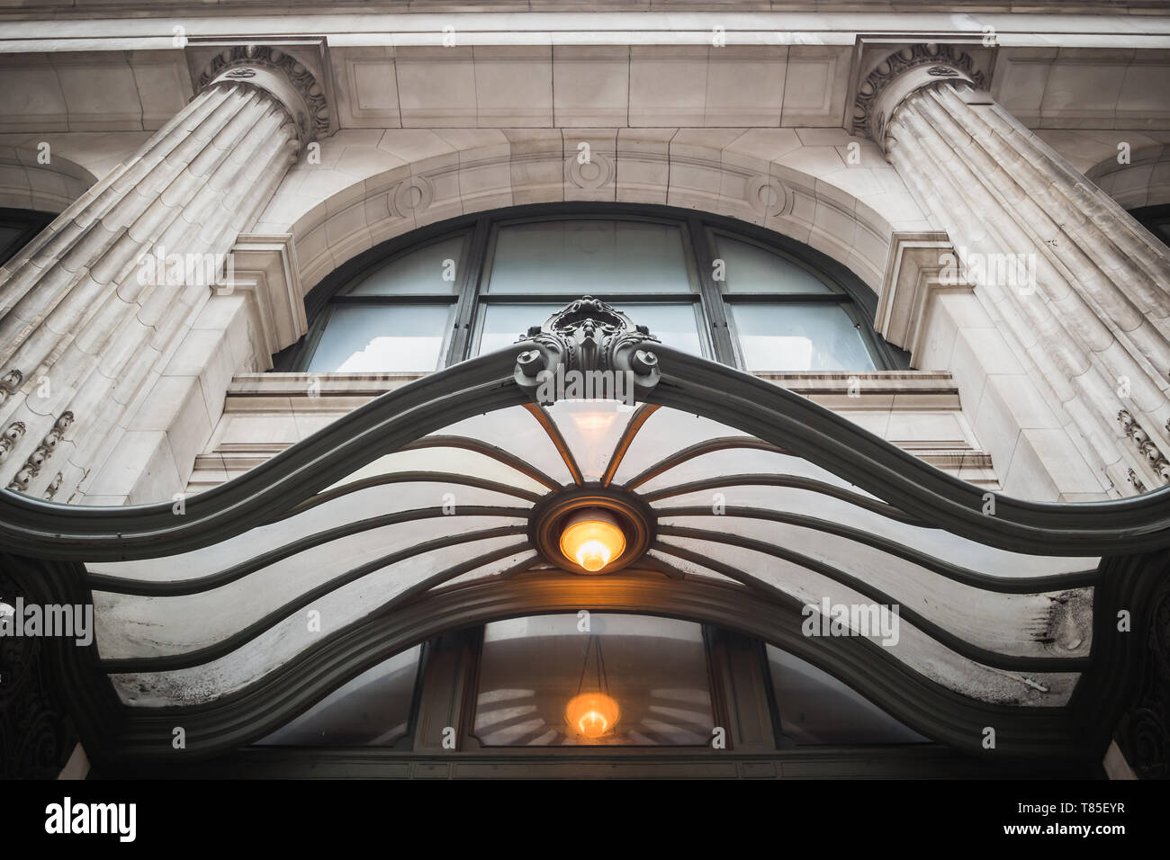 Facade of a building with columns above a canopy at the entrance of a ...