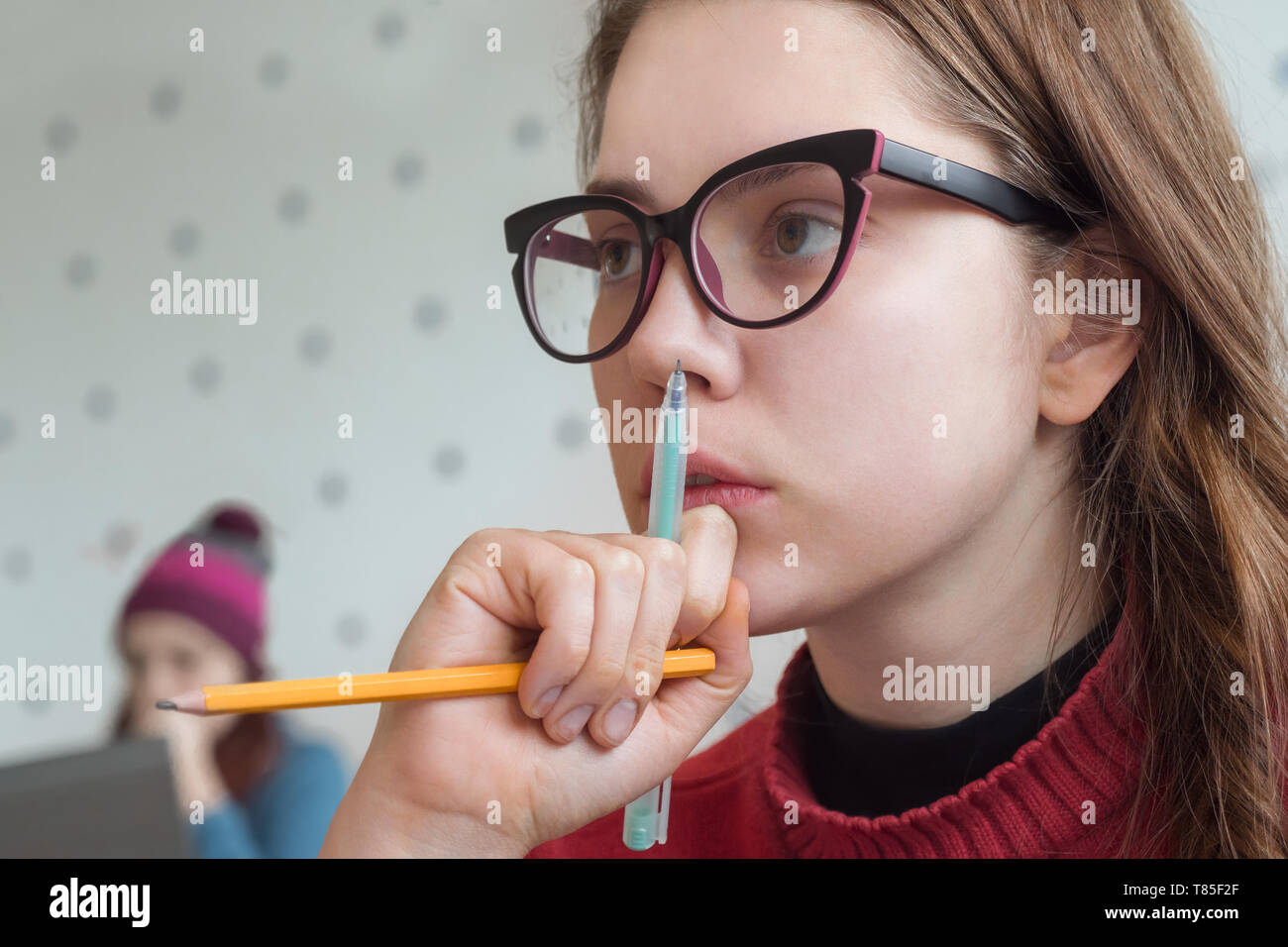 Thoughtful student at the university. Portrait of thinking female ...
