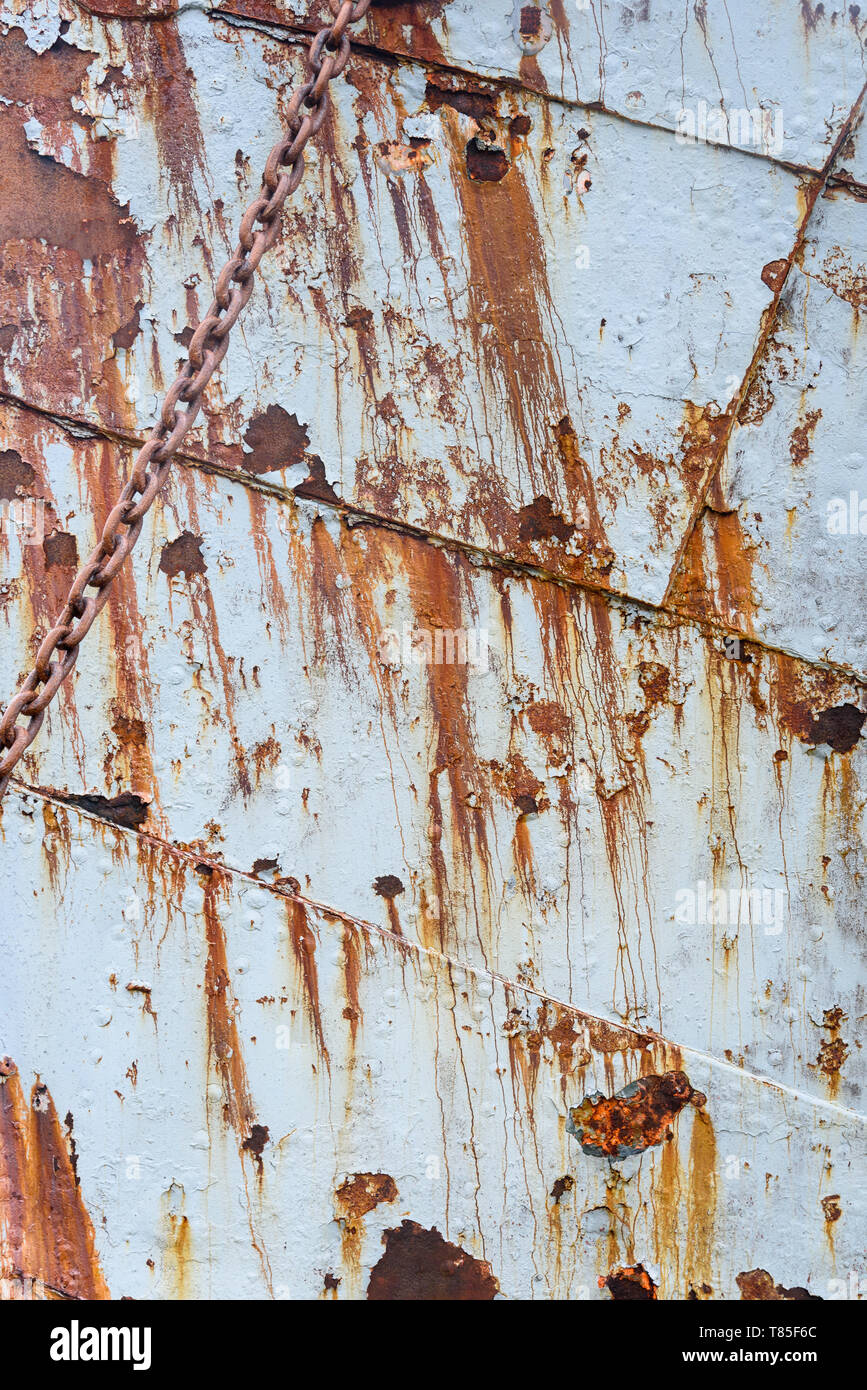 Peeling paint and rust steel hull of an abandoned whaling ship, as a ...