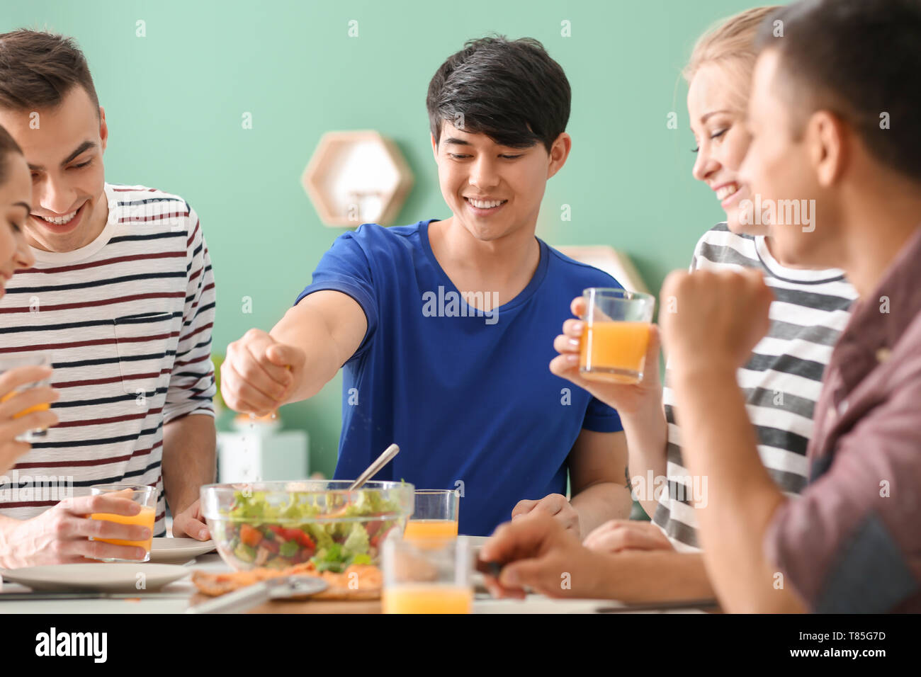 Eating pizza salad friends table hi-res stock photography and images ...