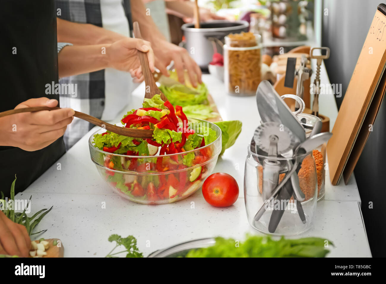 Friends cooking together in kitchen Stock Photo - Alamy