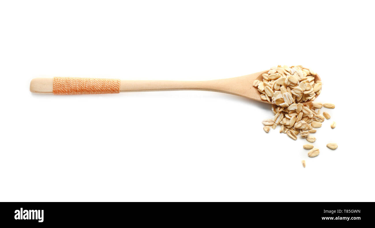 Spoon with raw oatmeal on white background Stock Photo - Alamy