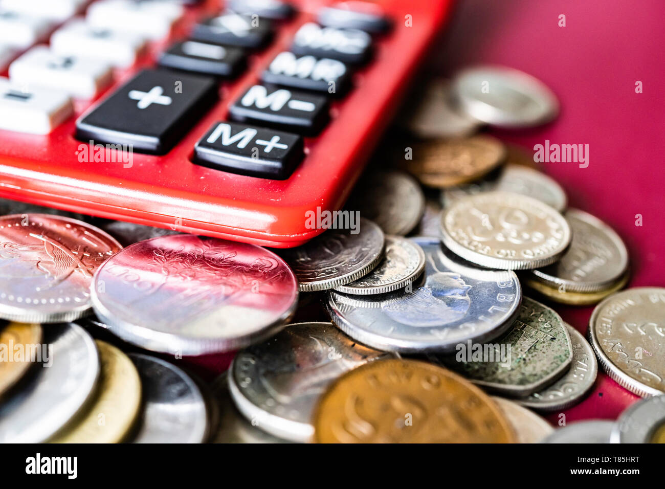 Red table top calculator with Silver coins - Business concept Stock ...