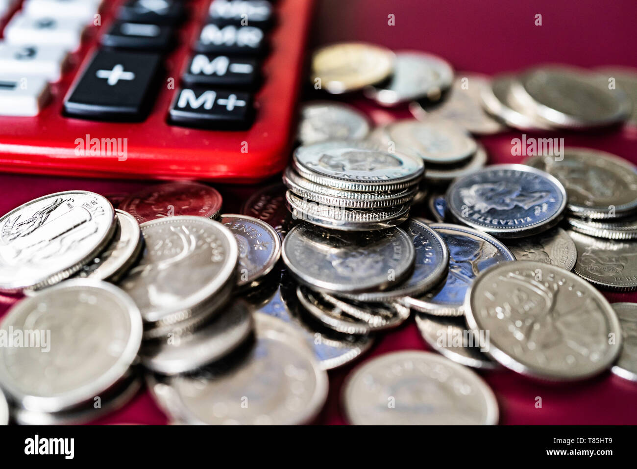 Red table top calculator with Silver coins - Business concept Stock ...