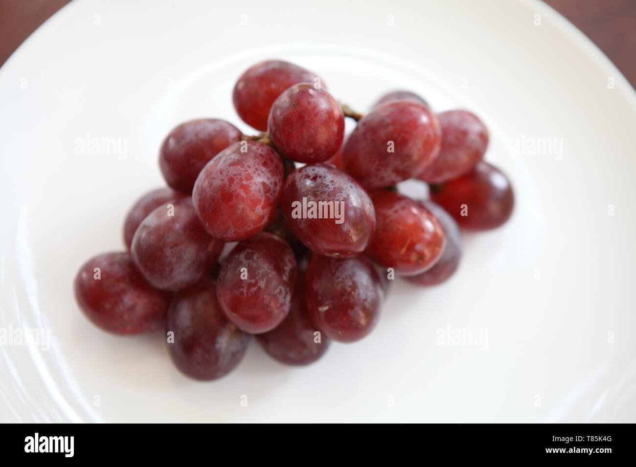 grapes on a plate Stock Photo - Alamy