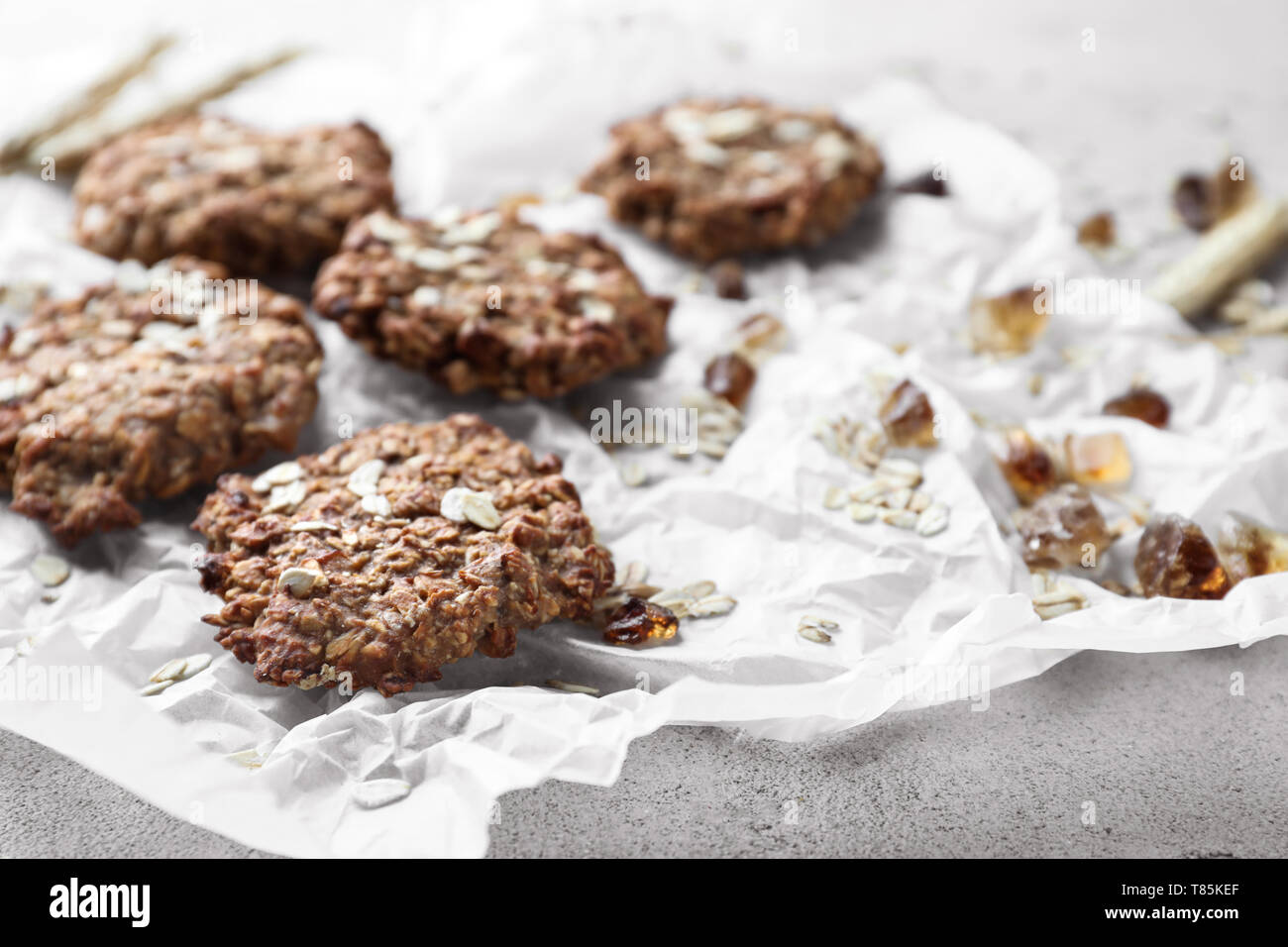 Parchment with delicious oatmeal cookies on light background Stock ...