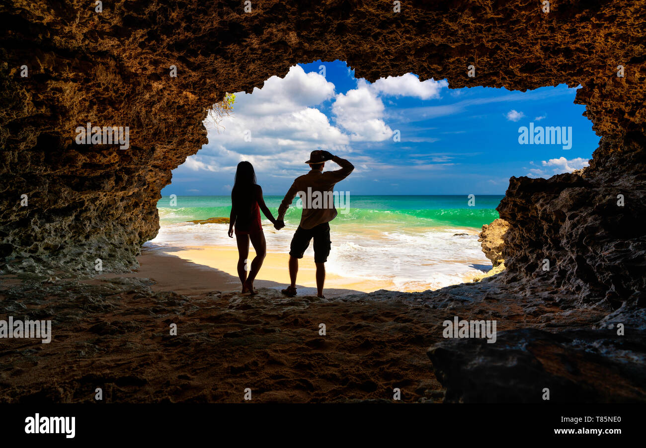 Couple in love enjoy honeymoon vacation in cave on tropical beach on ...