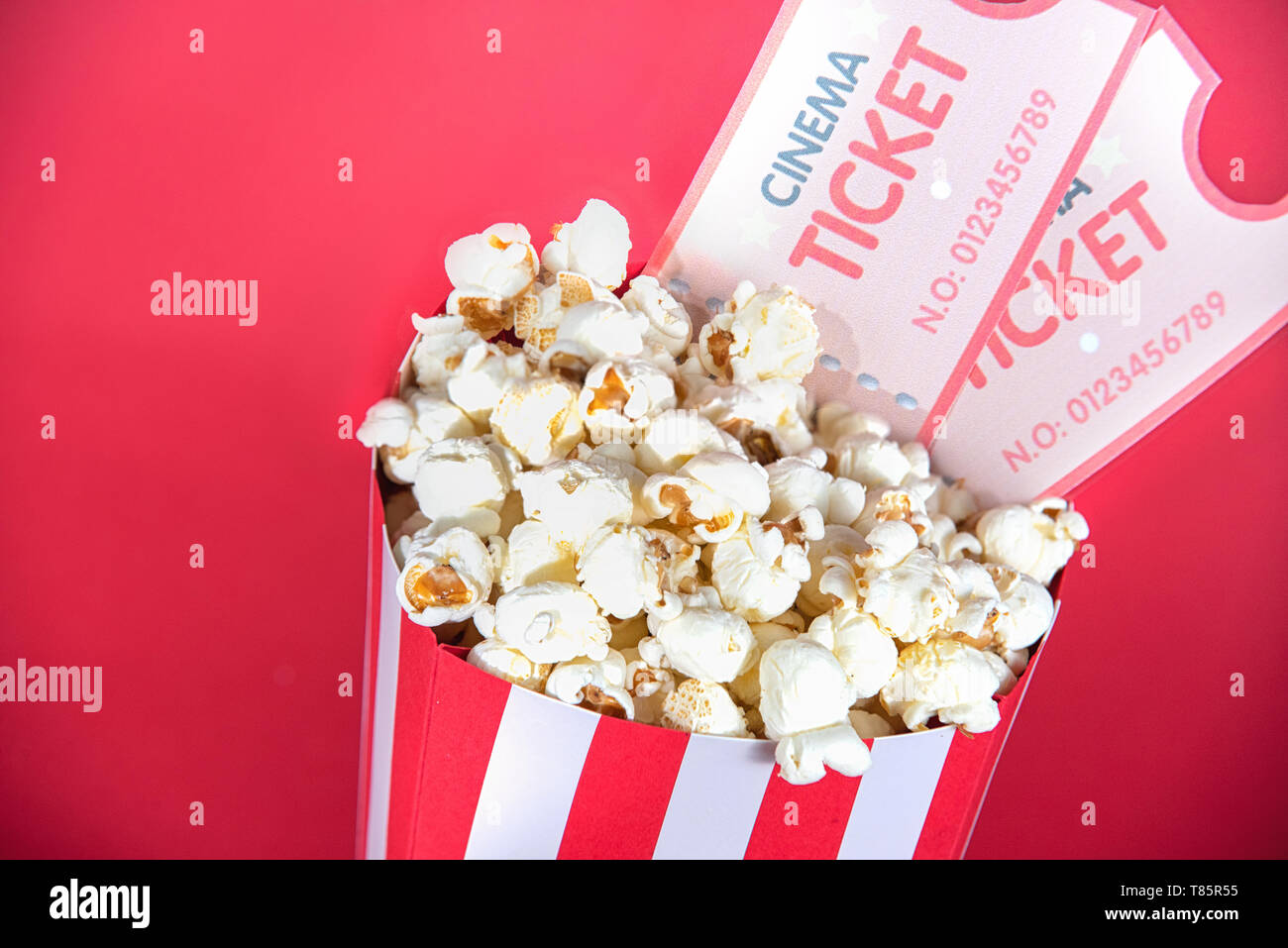 cinema pop corn and tickets on a red background Stock Photo - Alamy