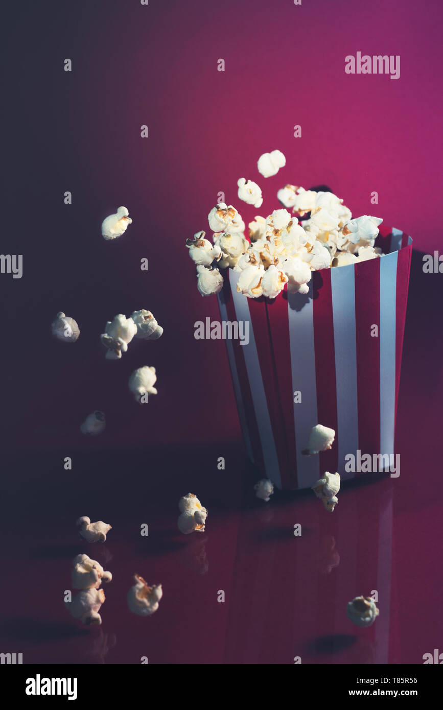 cinema pop corn jumping on a red background Stock Photo - Alamy