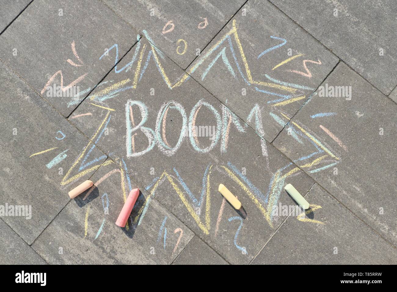 Text Boom drawing crayons on gray asphalt, top view Stock Photo - Alamy