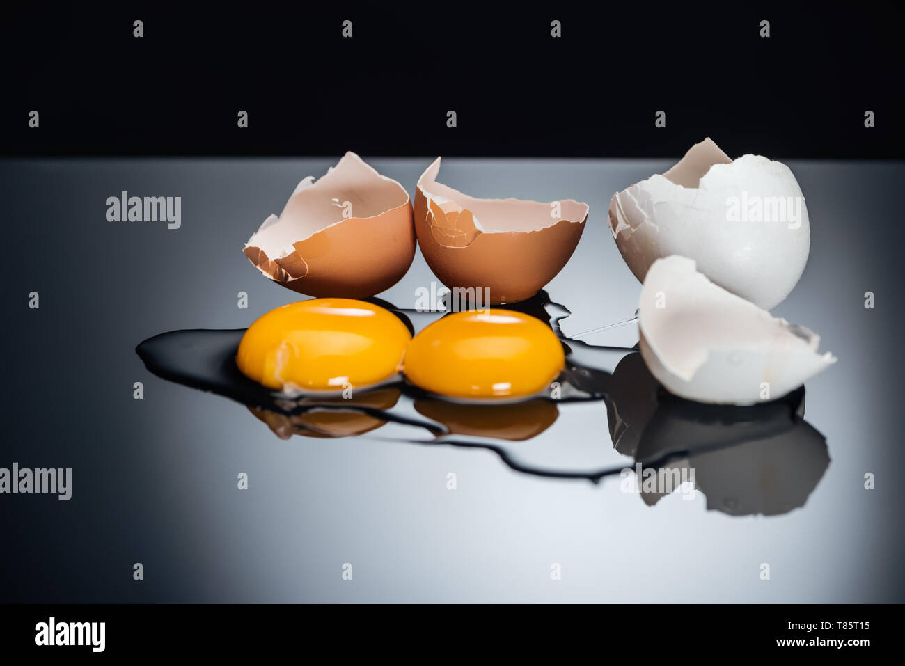 raw smashed chicken eggs with yolks, proteins and eggshell isolated on ...