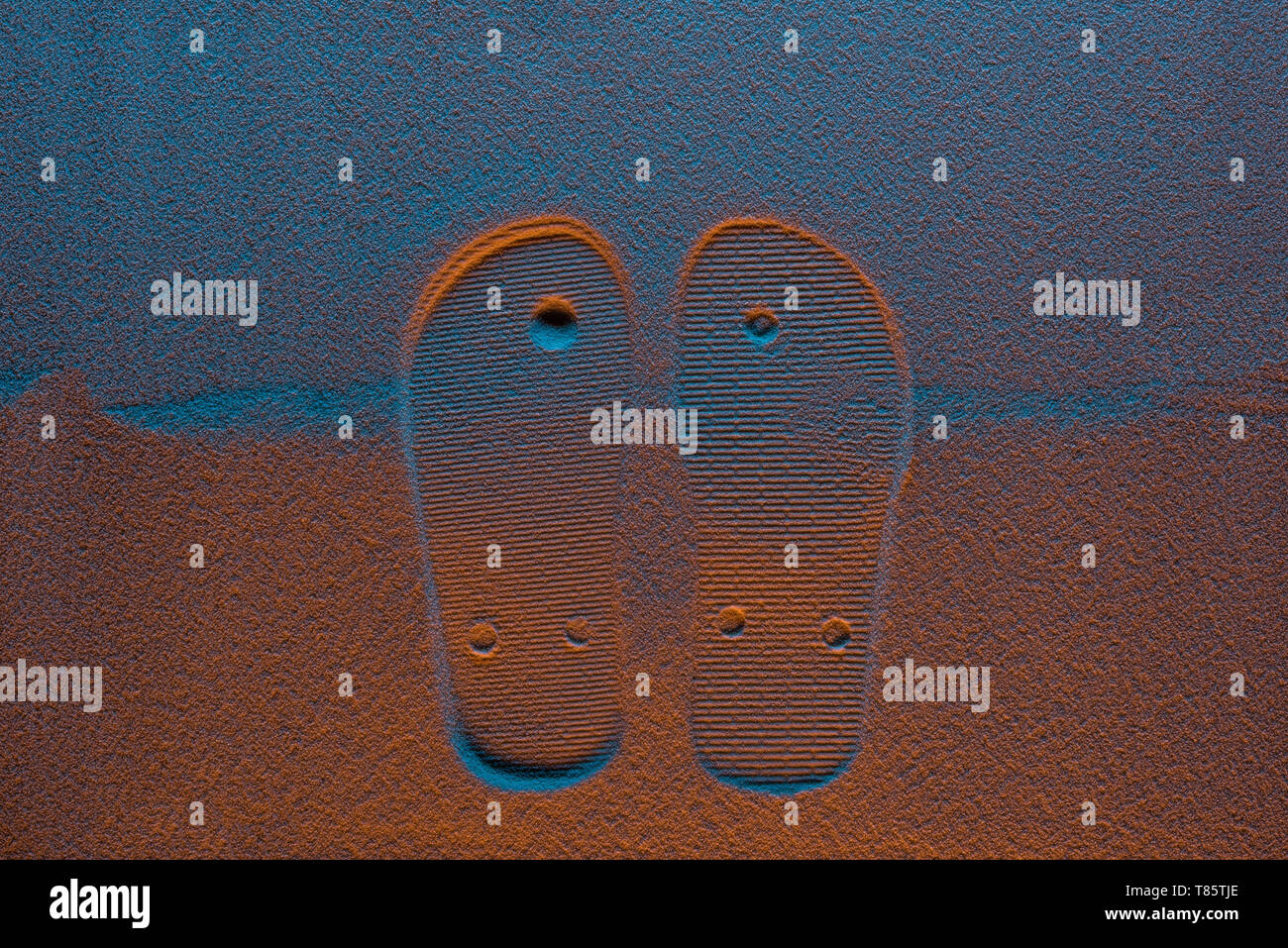 top view of flip flops mark on sand with color filter Stock Photo - Alamy