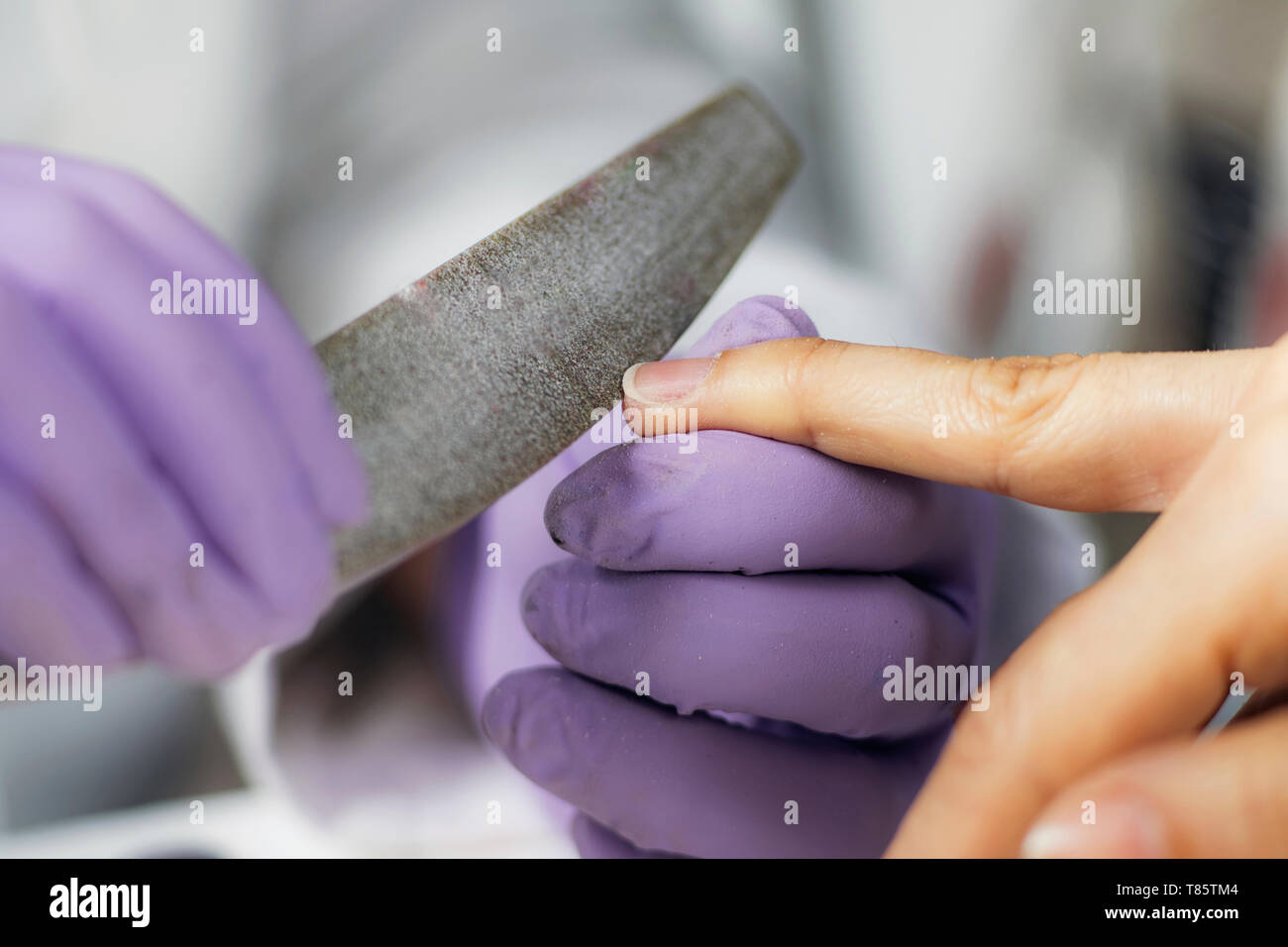 Female hands filing nails hi-res stock photography and images - Alamy