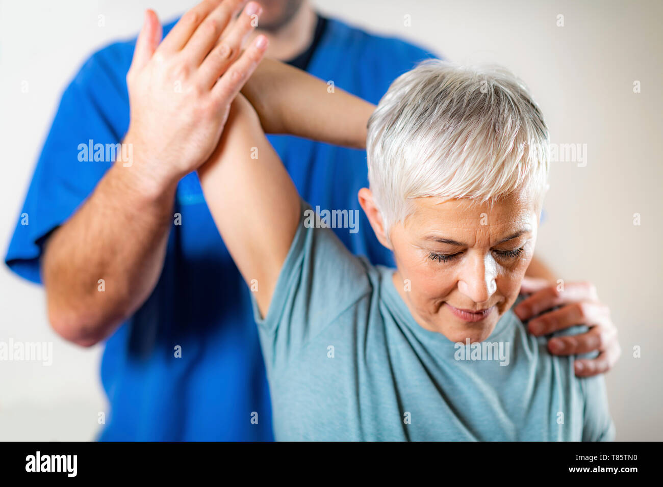 Physical therapist examining patient's shoulder Stock Photo - Alamy