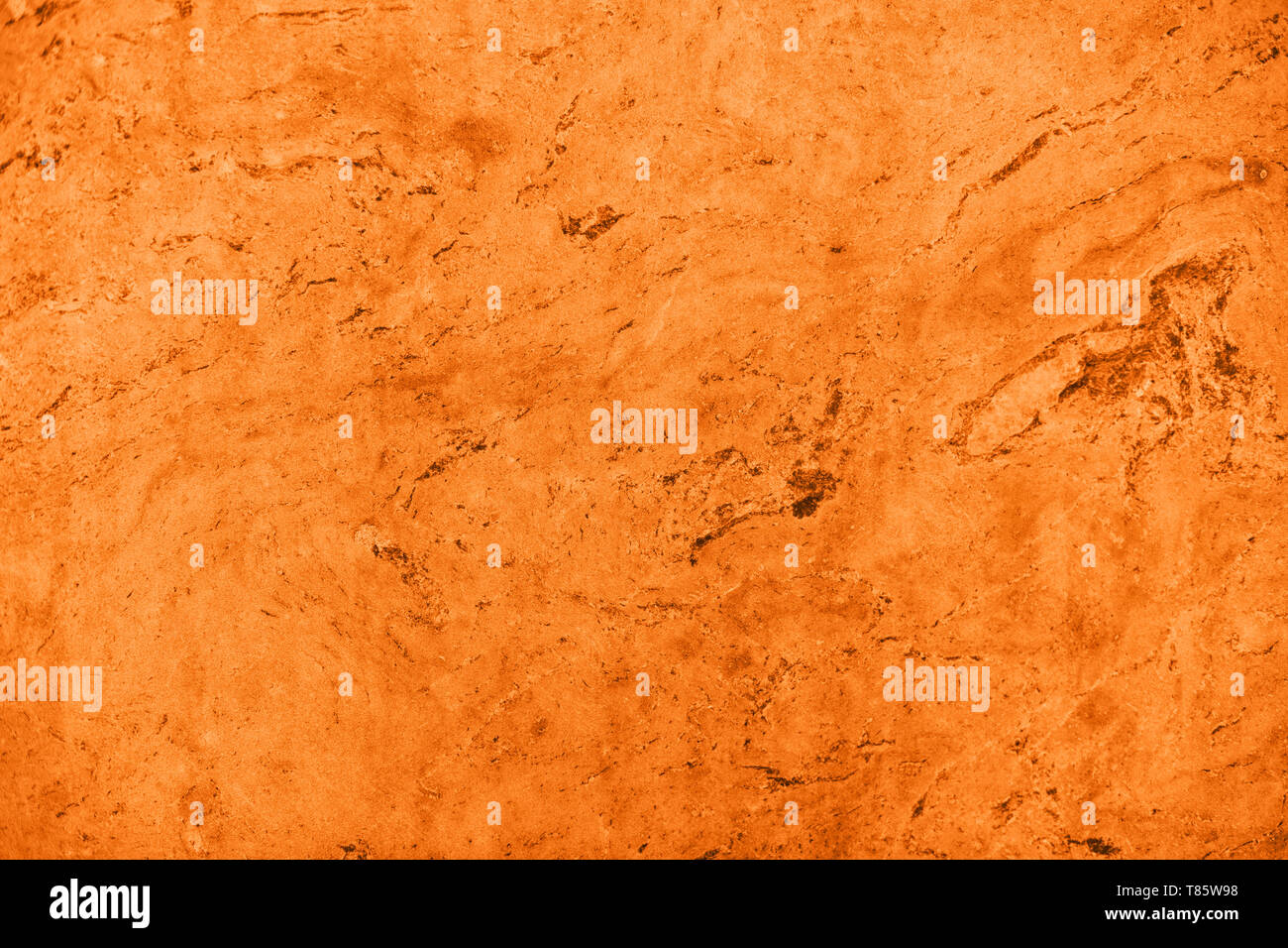 Close up of abstract turmeric orange toned granite stone texture with ...