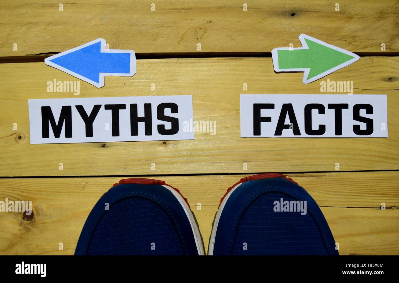 Myths or Facts opposite direction signs with sneakers on wooden vintage ...