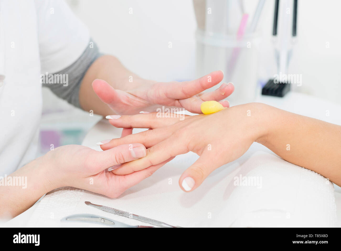 Hand cream application during manicure Stock Photo - Alamy