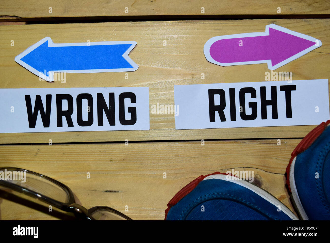Right or Wrong opposite direction signs with sneakers and eyeglasses on ...