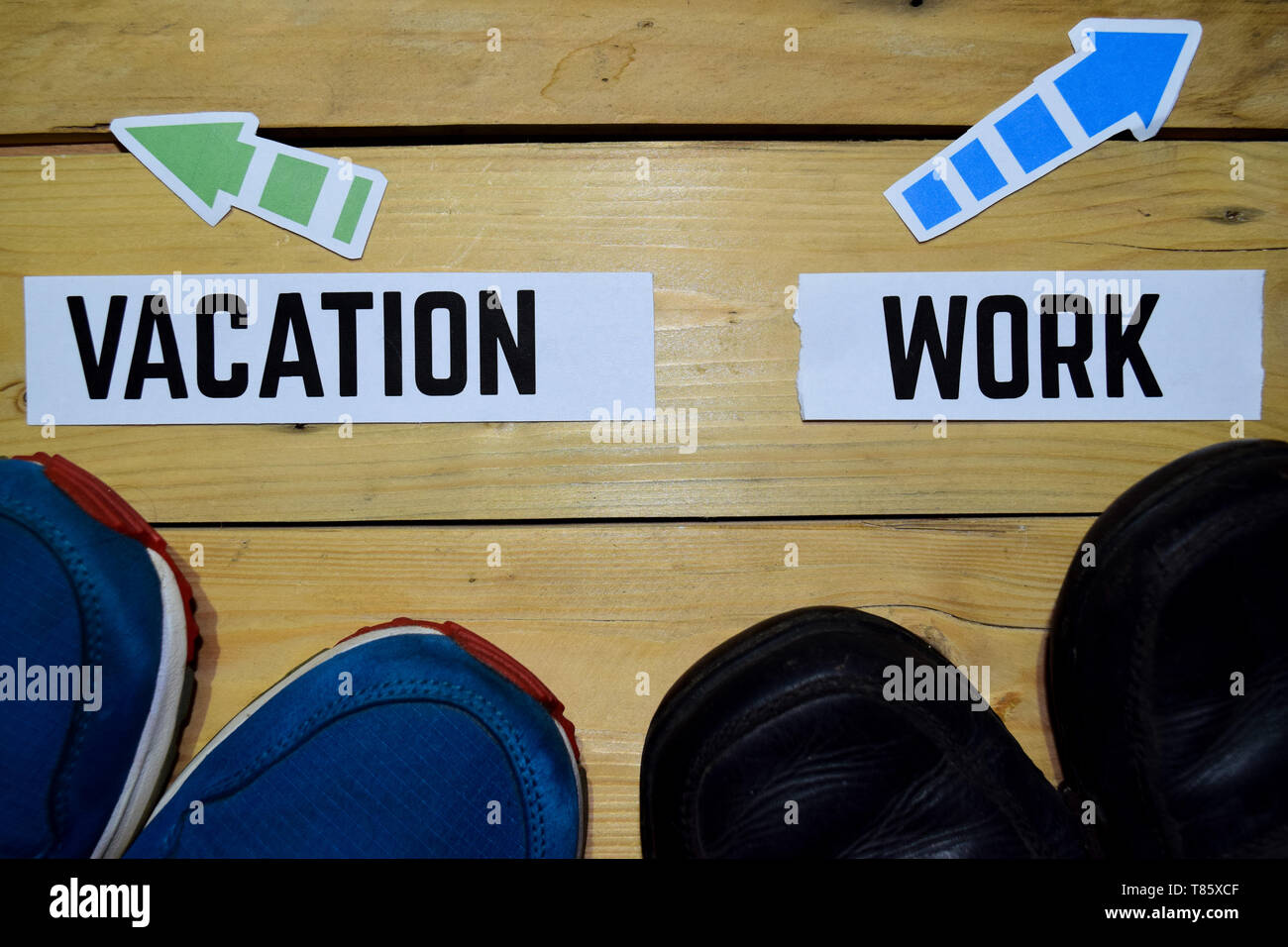 Vacation or Work opposite direction signs with sneakers and boots on ...