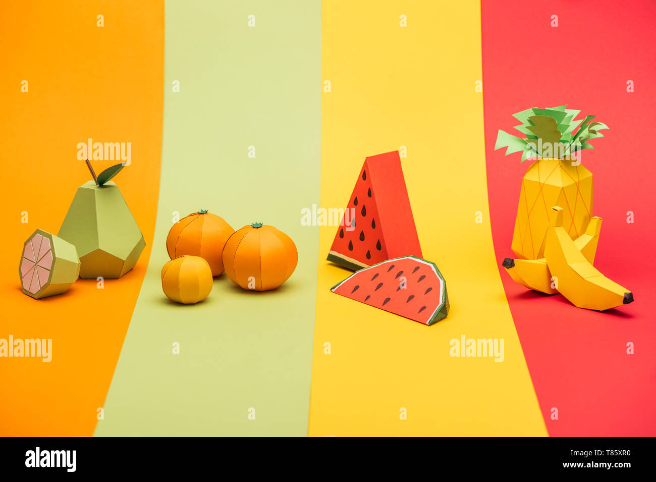 various handmade origami fruits on stripes of colorful paper Stock ...
