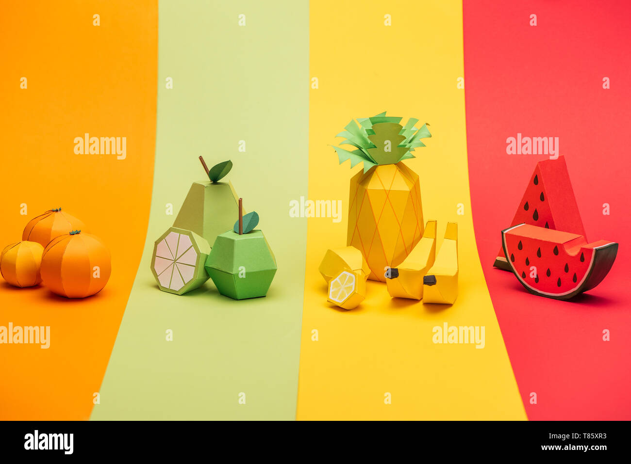 various handmade paper fruits on stripes of colorful paper Stock Photo ...