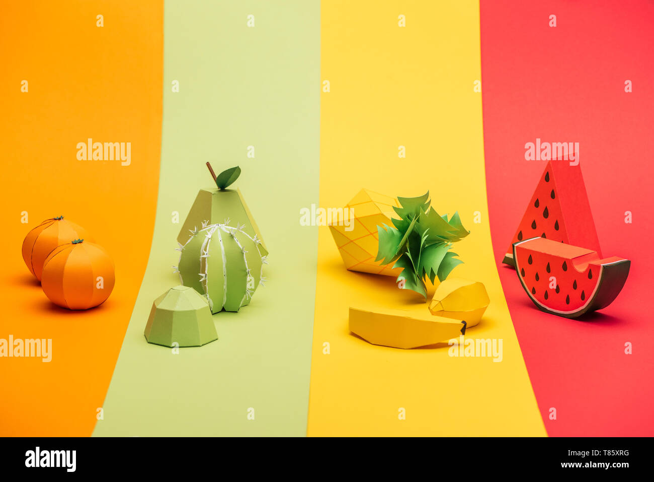 various handmade paper fruits on stripes of colorful paper Stock Photo ...