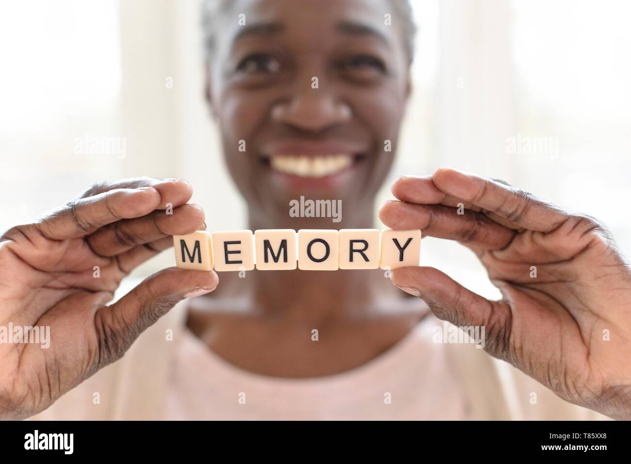 Woman holding word memory Stock Photo - Alamy