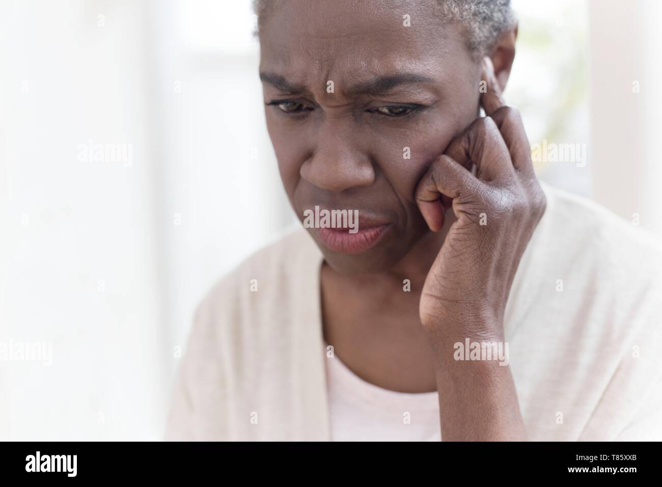 Woman touching ear finger hi-res stock photography and images - Alamy