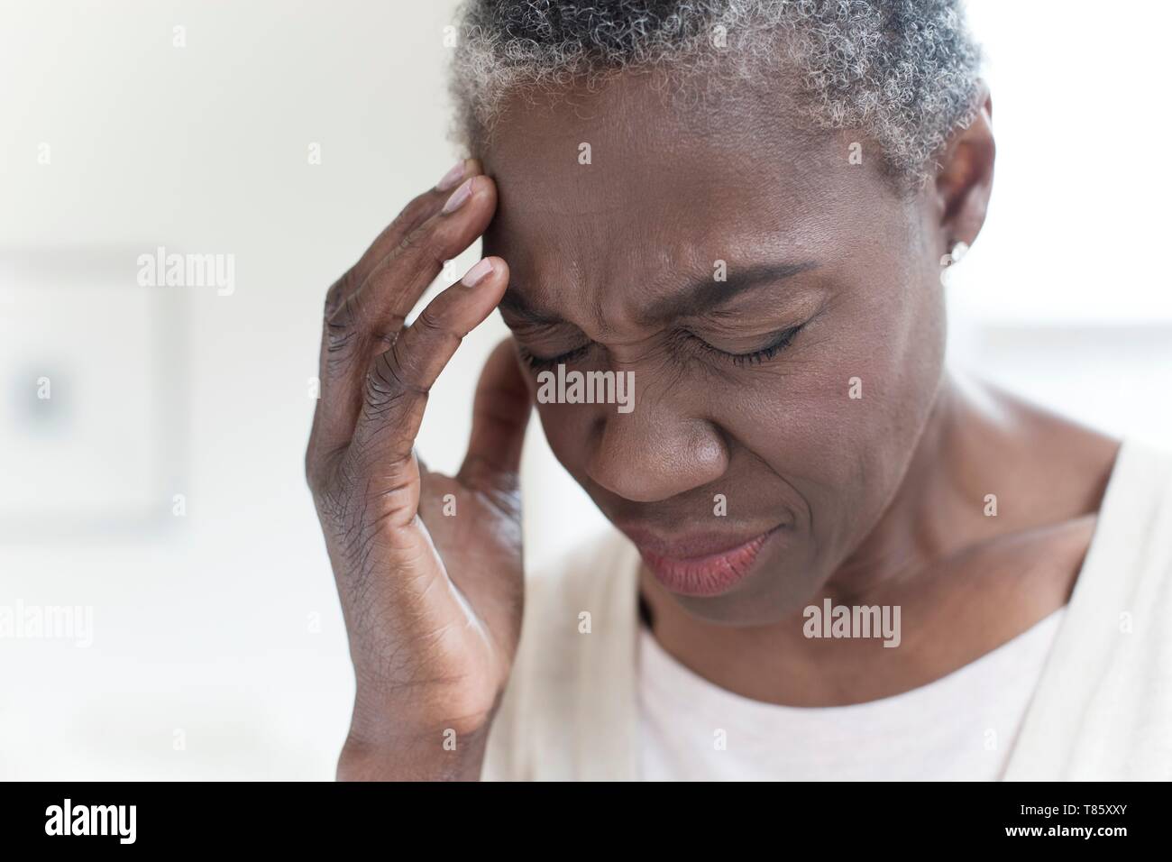 Woman touching head with hand Stock Photo - Alamy