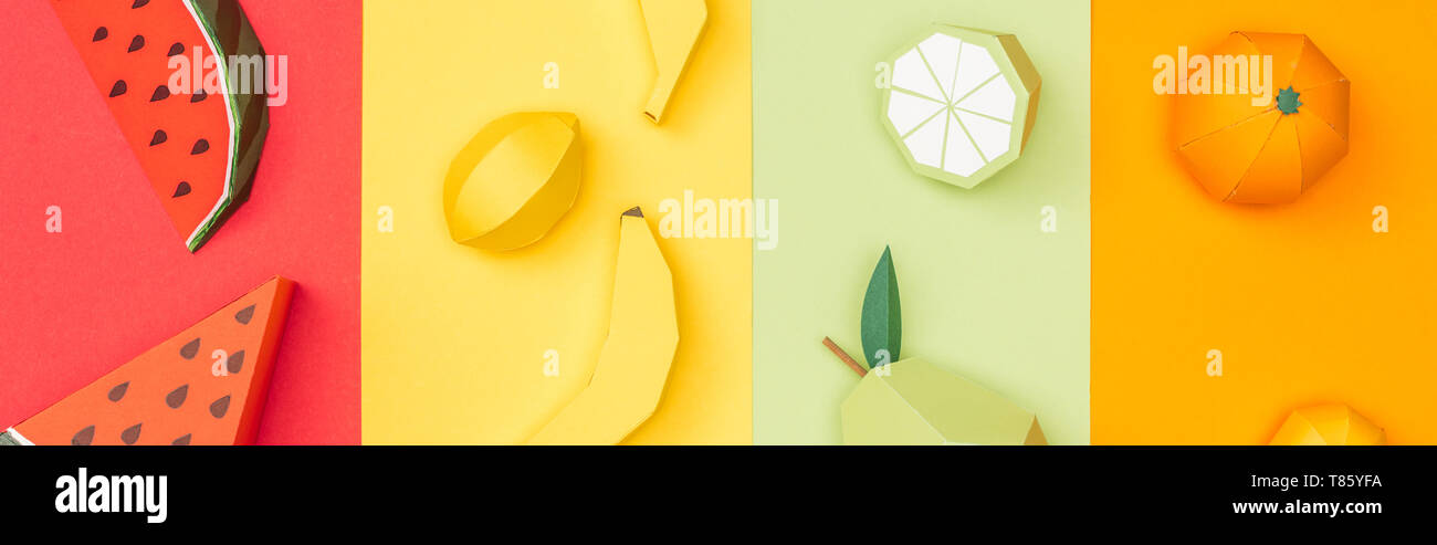 panoramic shot of various origami fruits on colorful paper stripes ...