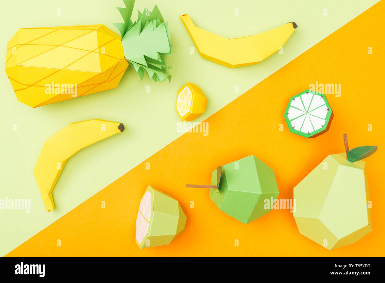 top view of handmade colorful origami fruits on orange and green Stock ...