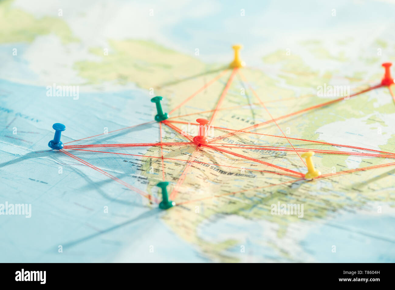 Selective focus of push pins and strings on world map Stock Photo - Alamy