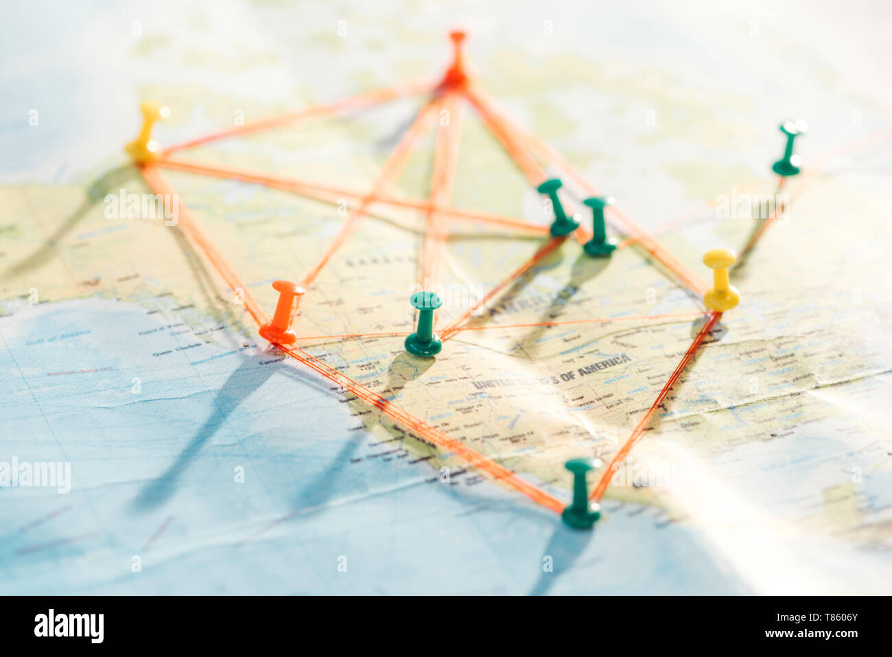 Selective focus of push pins and strings on world map Stock Photo - Alamy