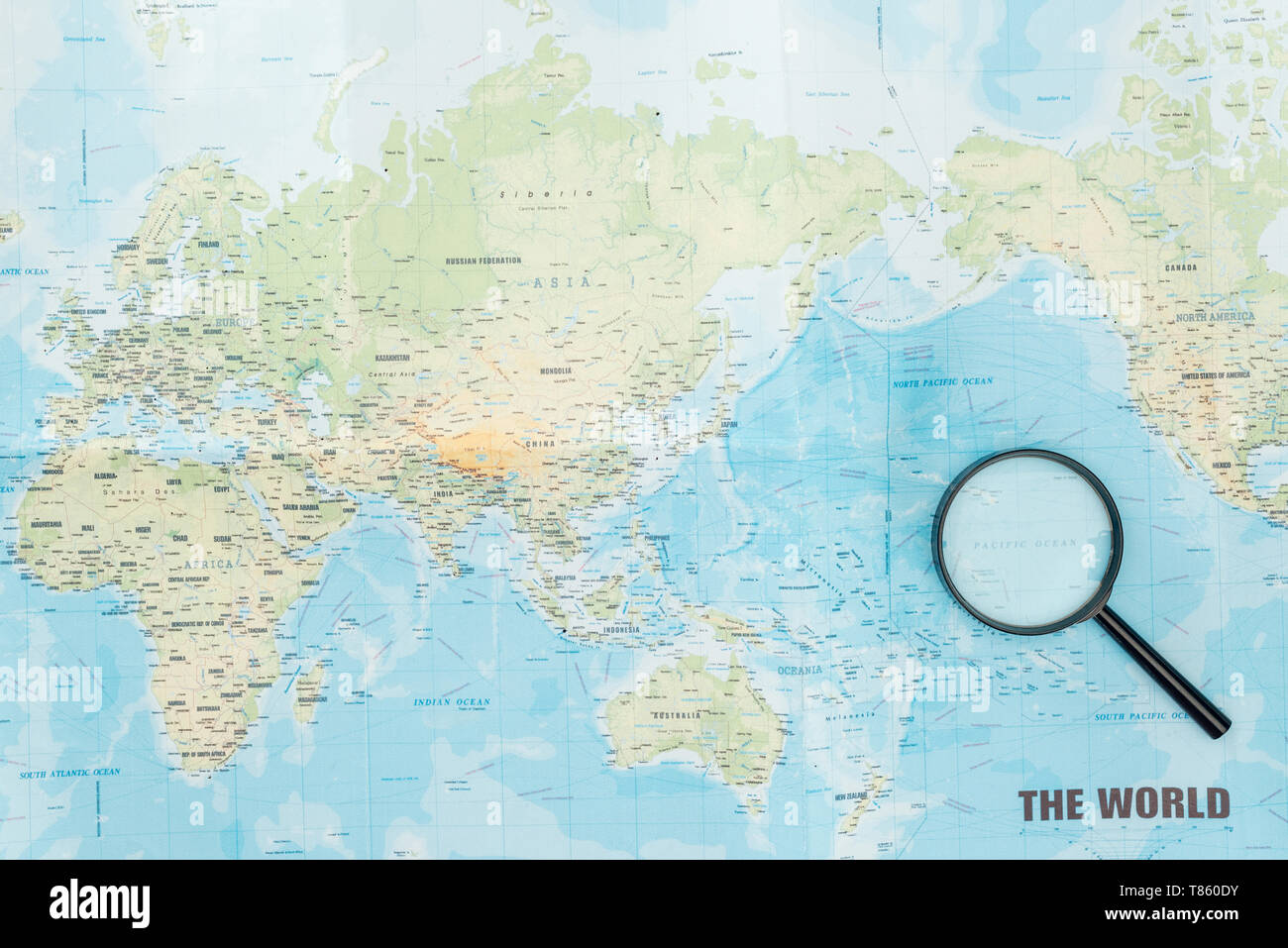 Top view of magnifying glass on world map Stock Photo - Alamy