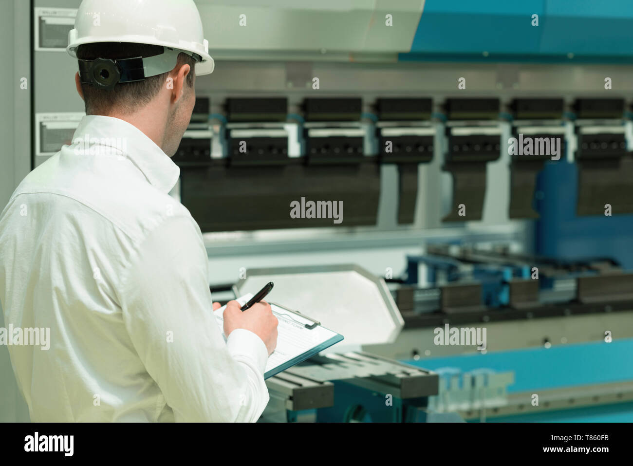 Engineer working in factory Stock Photo - Alamy
