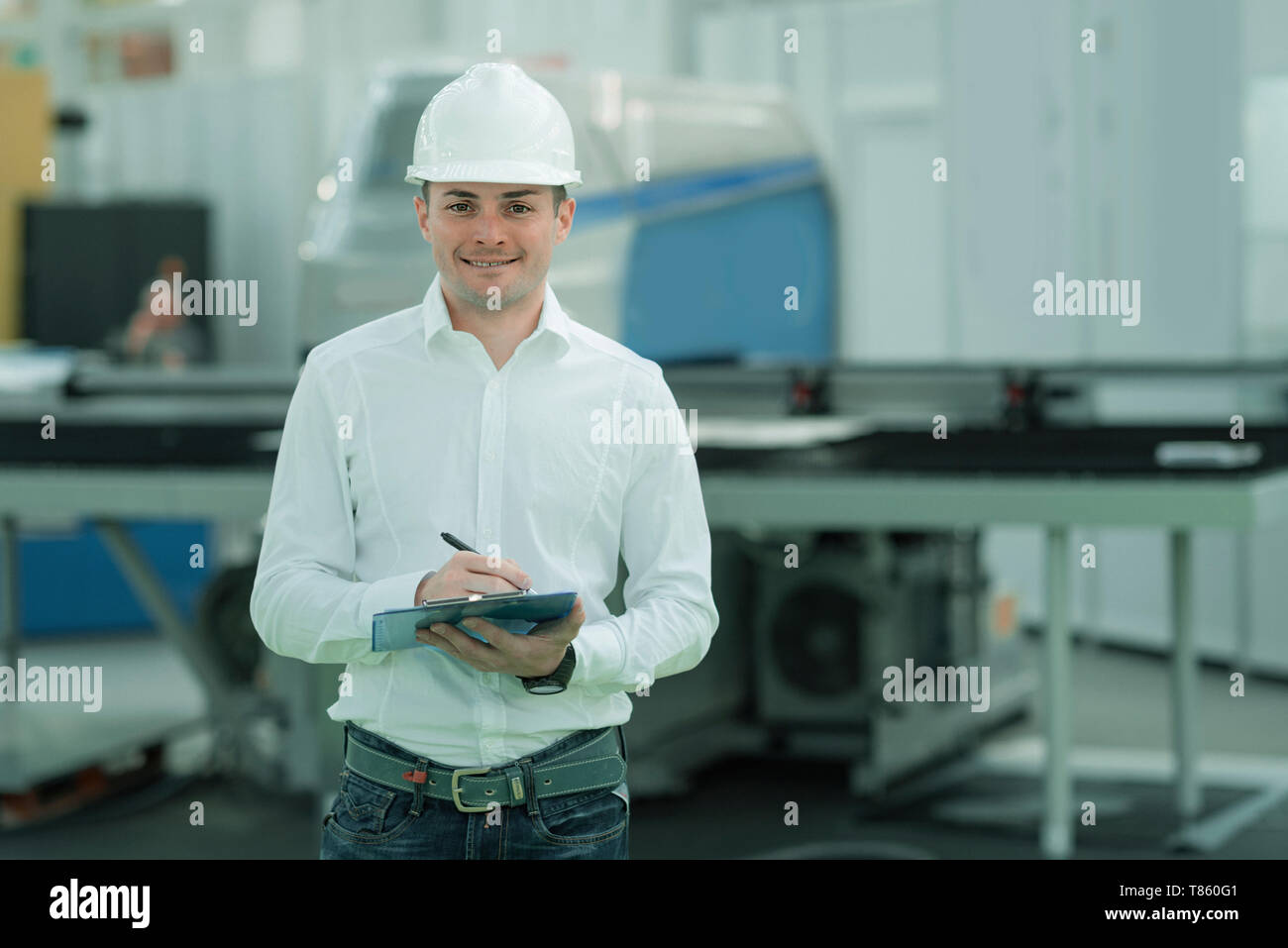 Engineer working in factory Stock Photo - Alamy