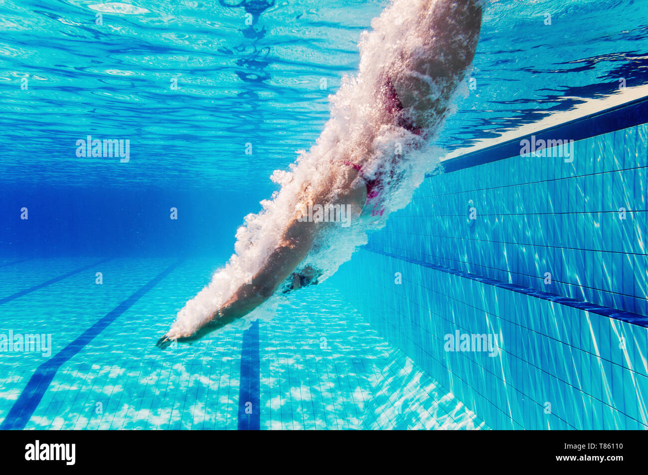 Swimmer diving into pool Stock Photo - Alamy