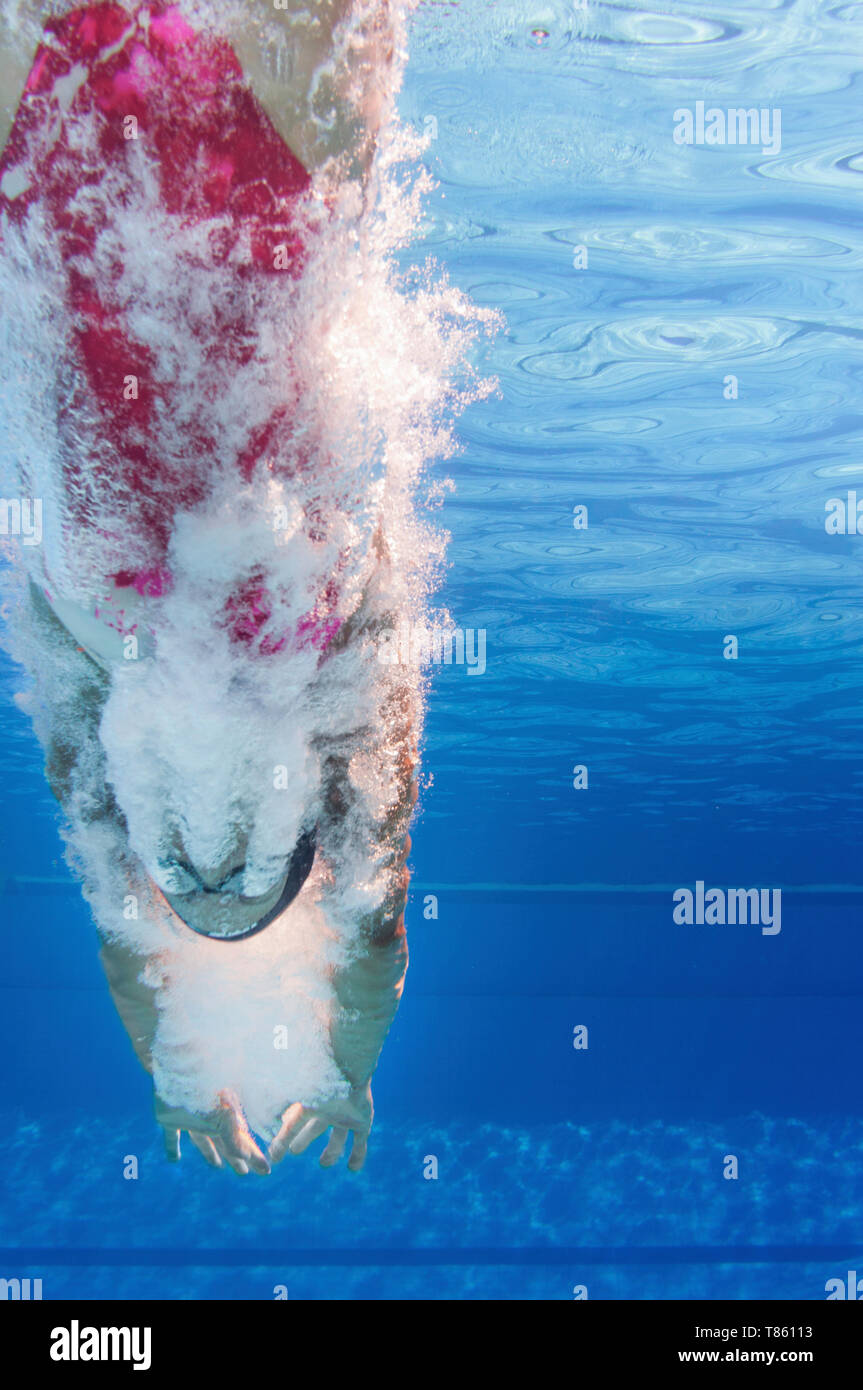 Woman diving swimming pool splash hi-res stock photography and images ...