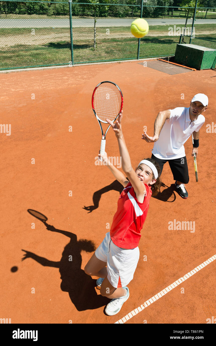 Child throwing tennis ball hi-res stock photography and images - Alamy