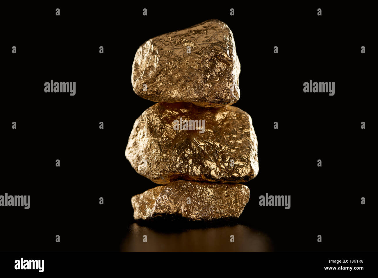 pile of gold textured shiny stones isolated on black Stock Photo - Alamy