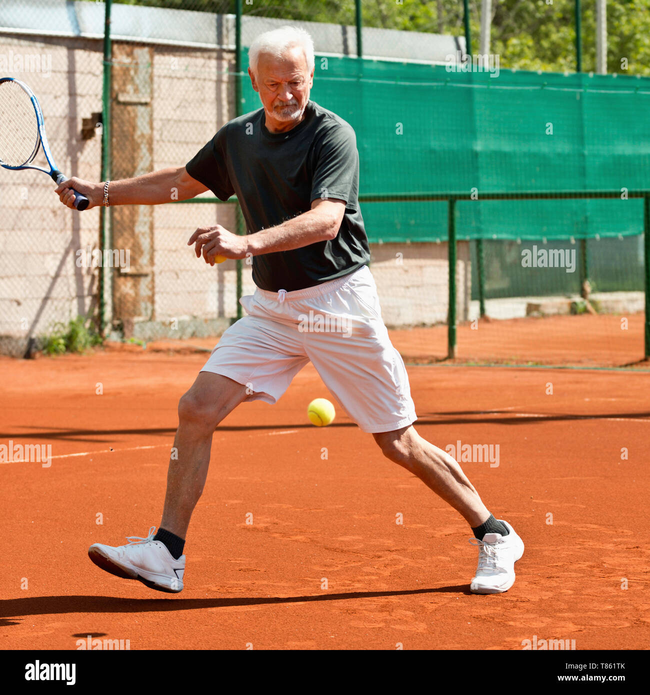 Active senior man playing tennis Stock Photo - Alamy